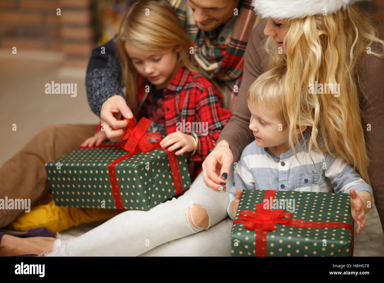 Happy children open Christmas gifts Stock Photo - Alamy