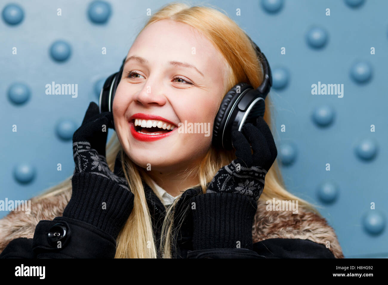 Beautiful ginger girl in headphones enjoying music Stock Photo - Alamy