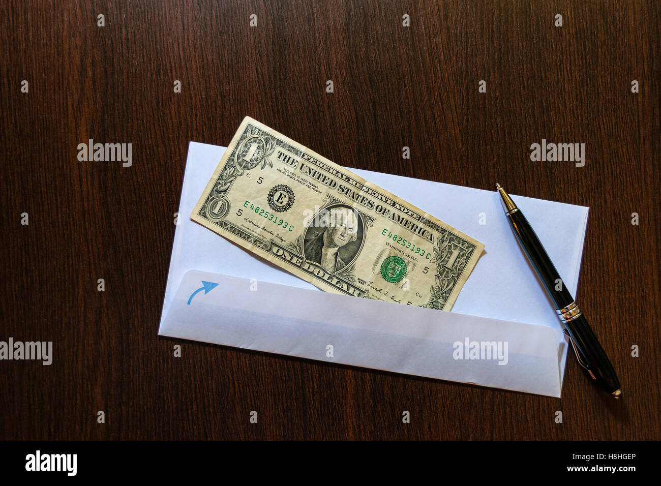 White envelope with one dollar Stock Photo - Alamy