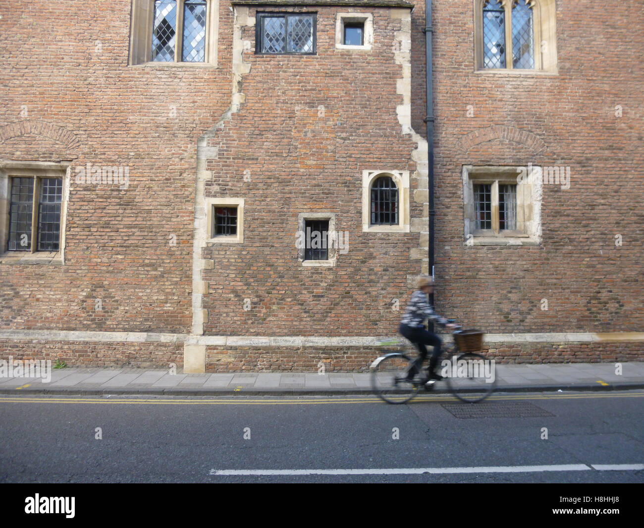 Cycling past college, Cambridge Stock Photo - Alamy