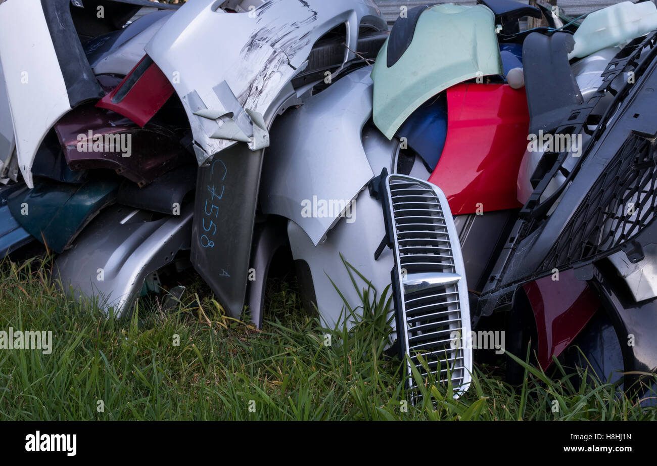 Broken and damaged bumpers and grill parts of cars stack up for ...