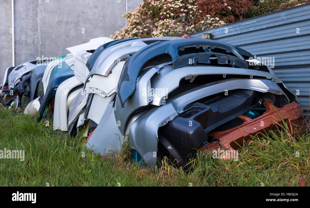Broken and damaged bumpers and grill parts of cars stack up for ...