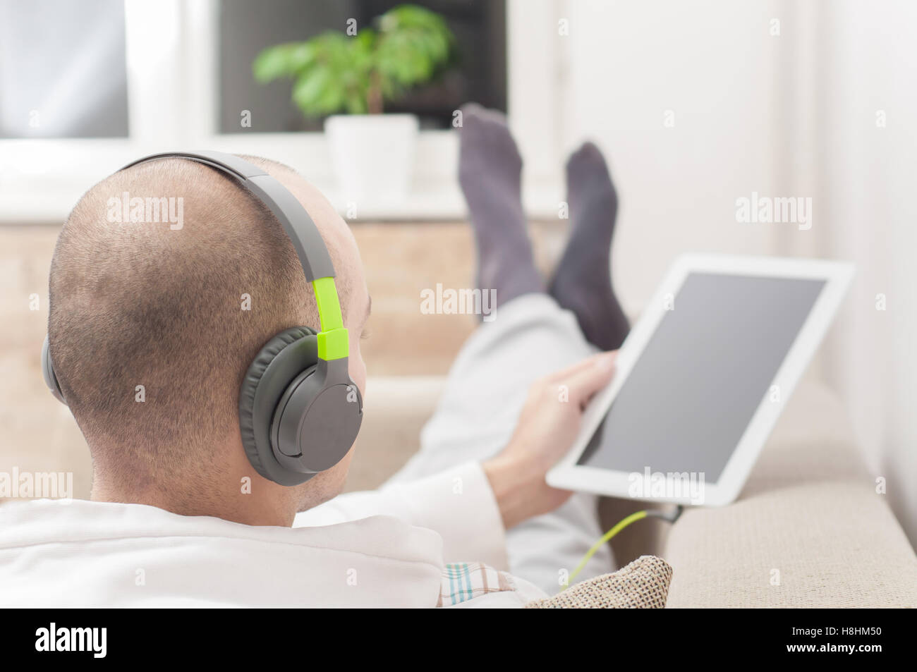 Anonymous man listening headphones hi-res stock photography and images ...