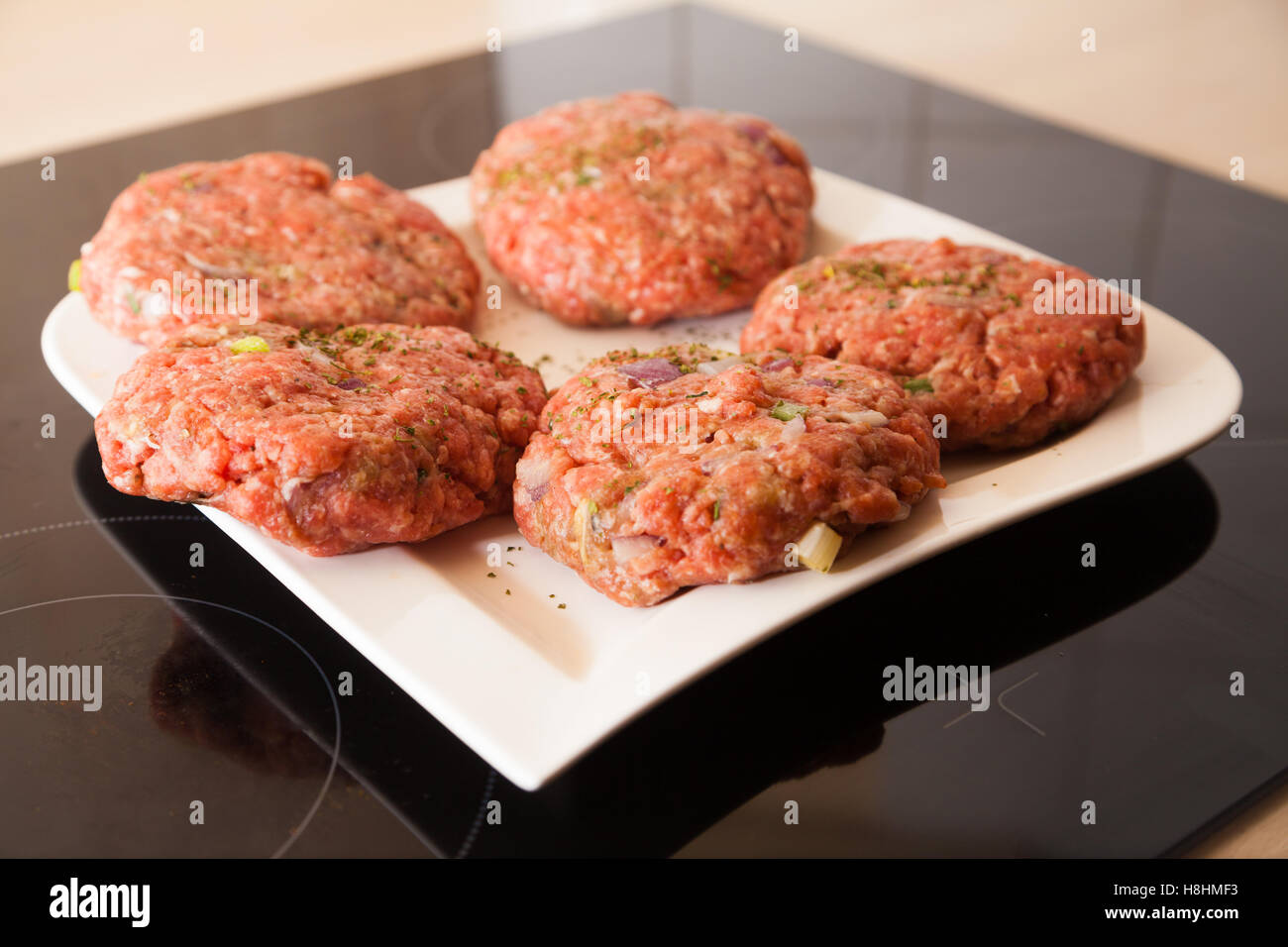 raw meat burger lies on a plate Stock Photo - Alamy