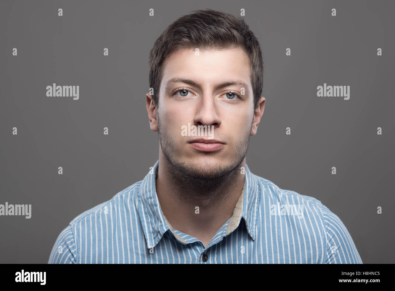 Young confident successful male ceo in blue shirt looking at camera ...