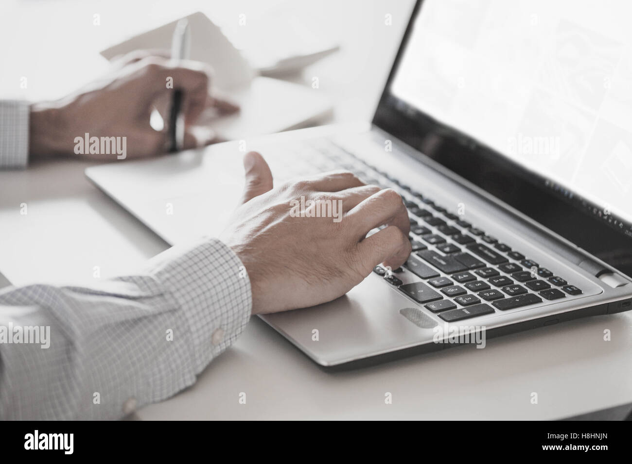 Working at home with laptop man Stock Photo - Alamy