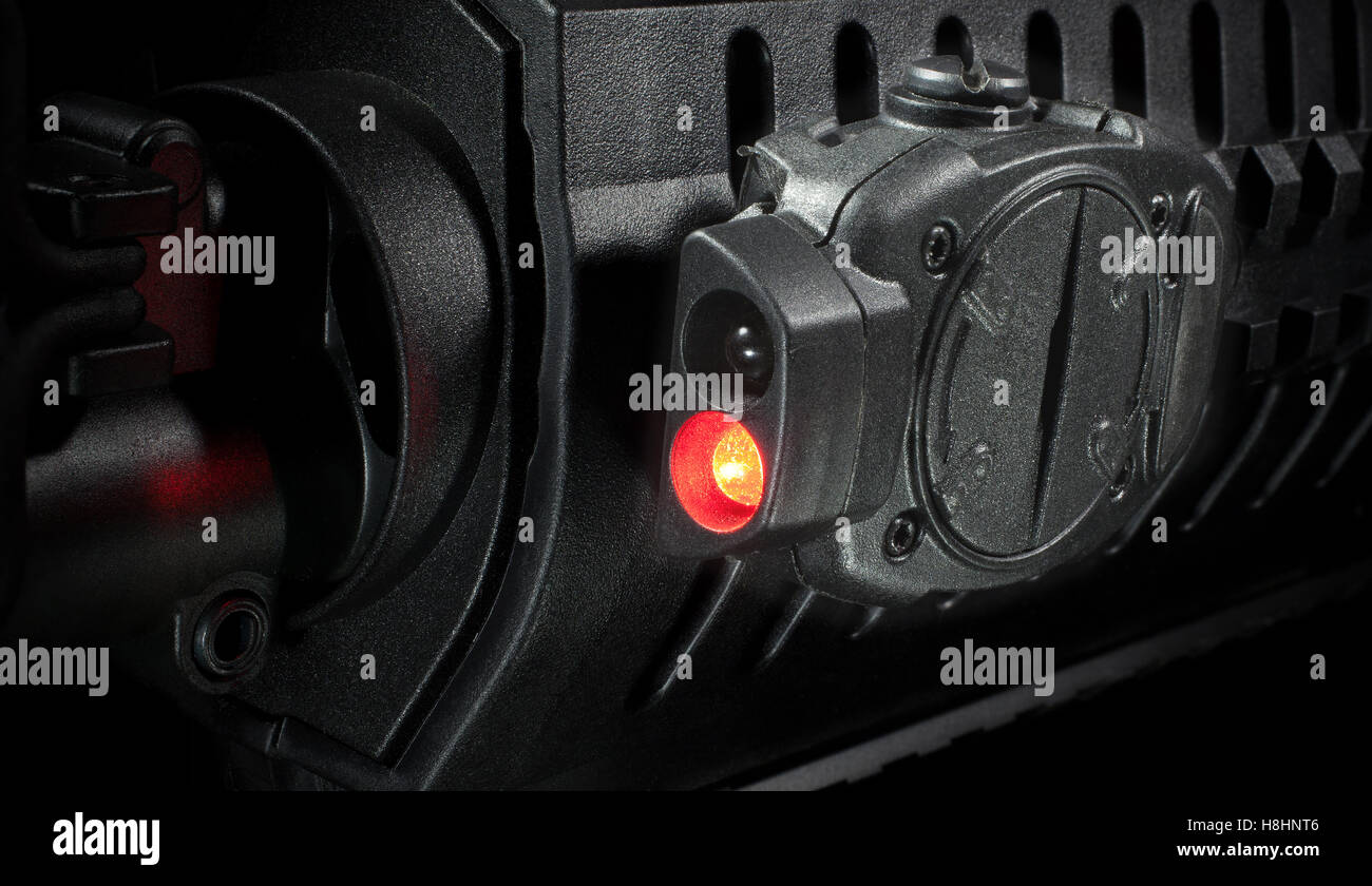 Weaponlight mounted on a rifle that is emitting a red light Stock Photo ...