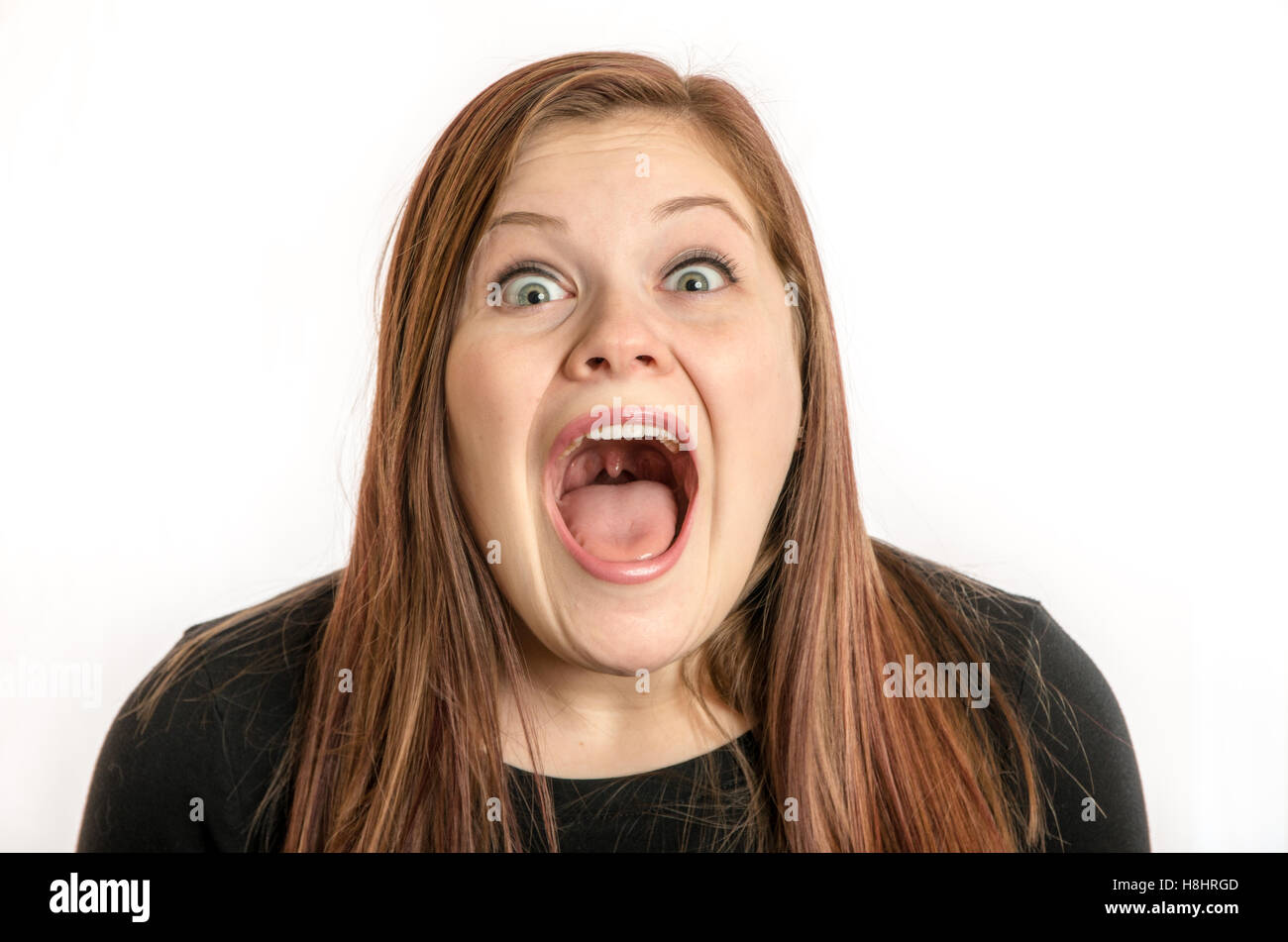Isolated female teen making odd faces Stock Photo - Alamy