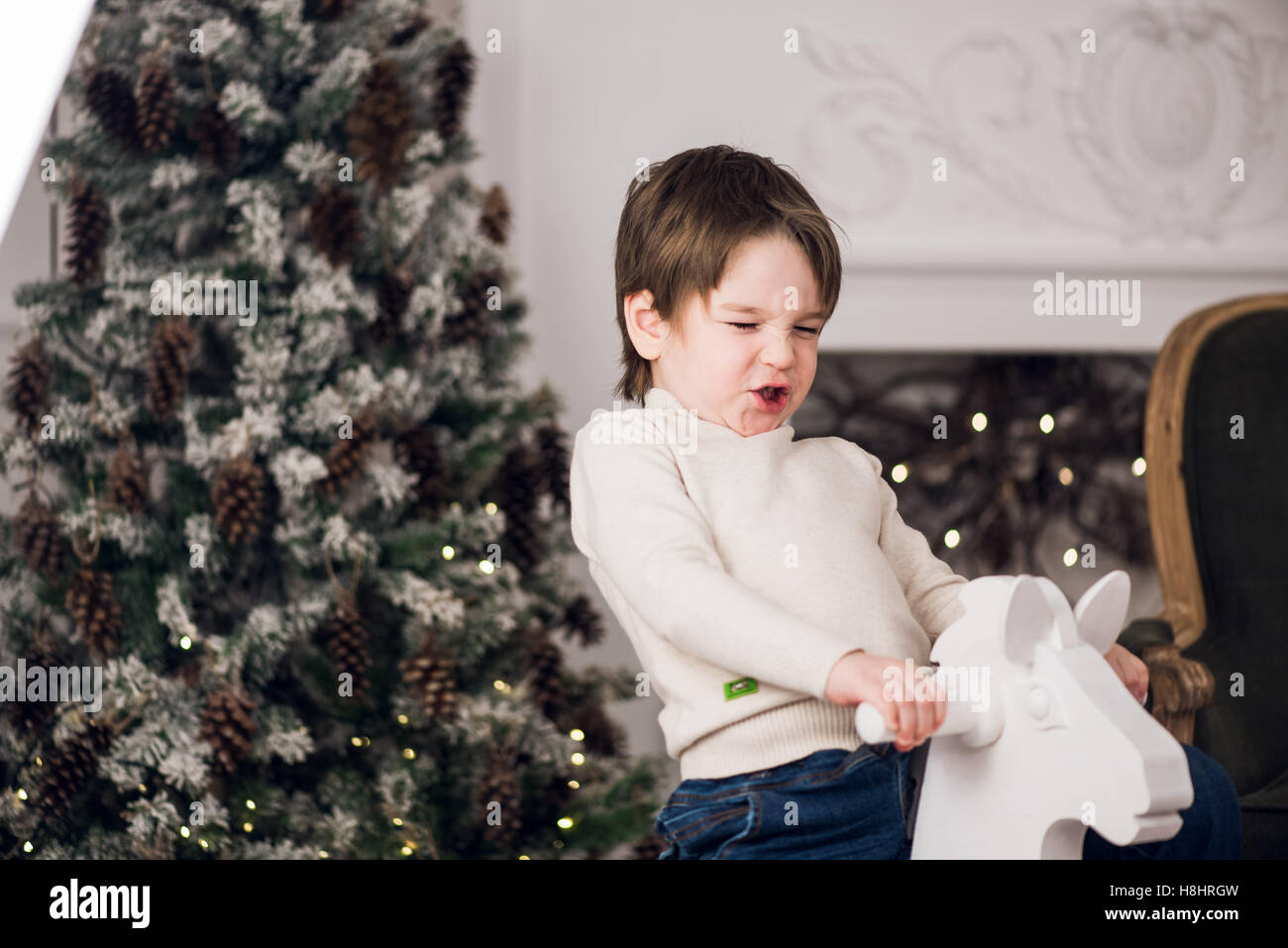 Boy riding rocking horse hi-res stock photography and images - Alamy