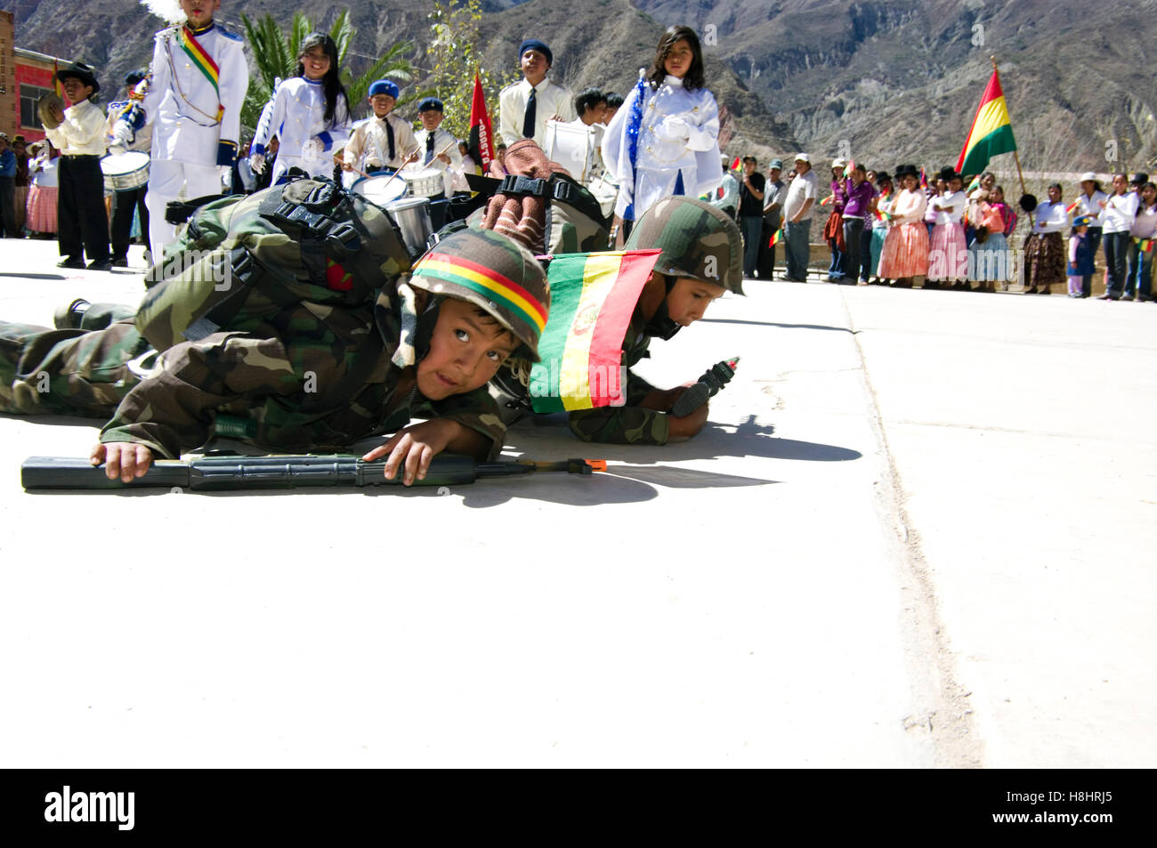 Parade in rural Bolivia with fancy dress child soldiers crawling on the ...