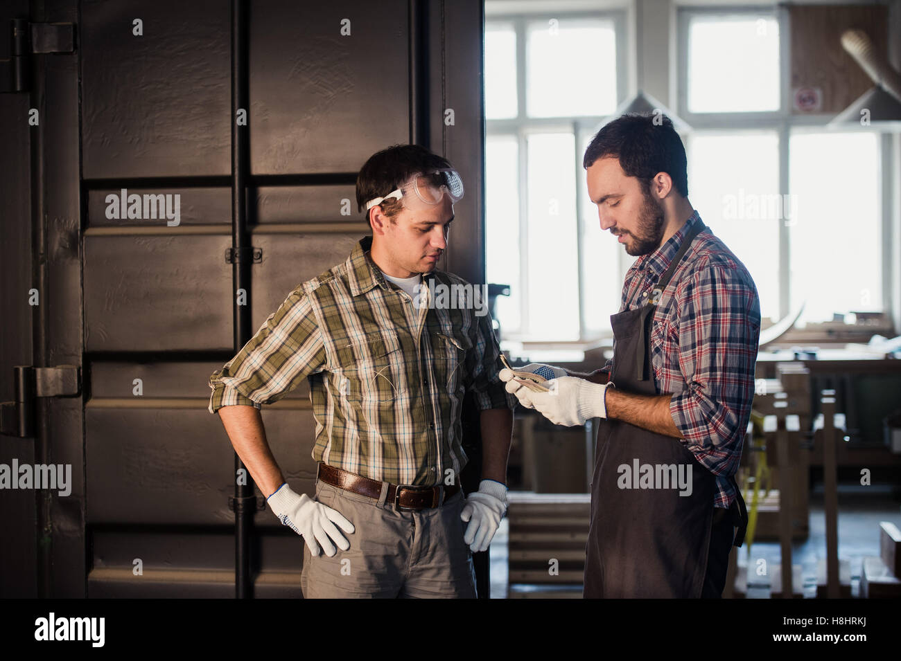 Young carpenter gets money for his work in workshop carpentry Stock ...