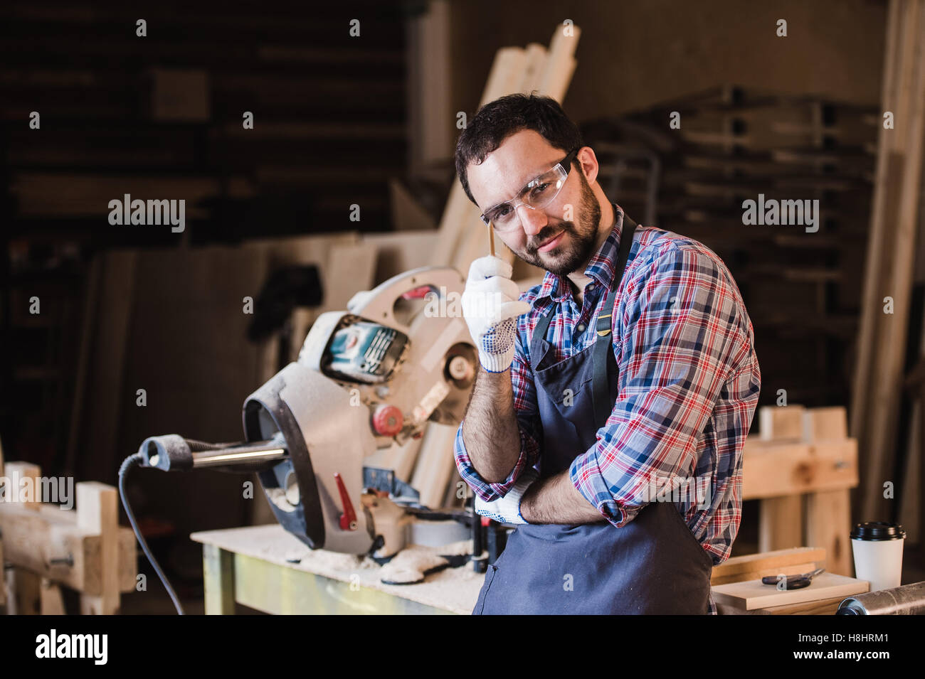 Handsome young handyman carpenter in workshop, smiling Stock Photo - Alamy