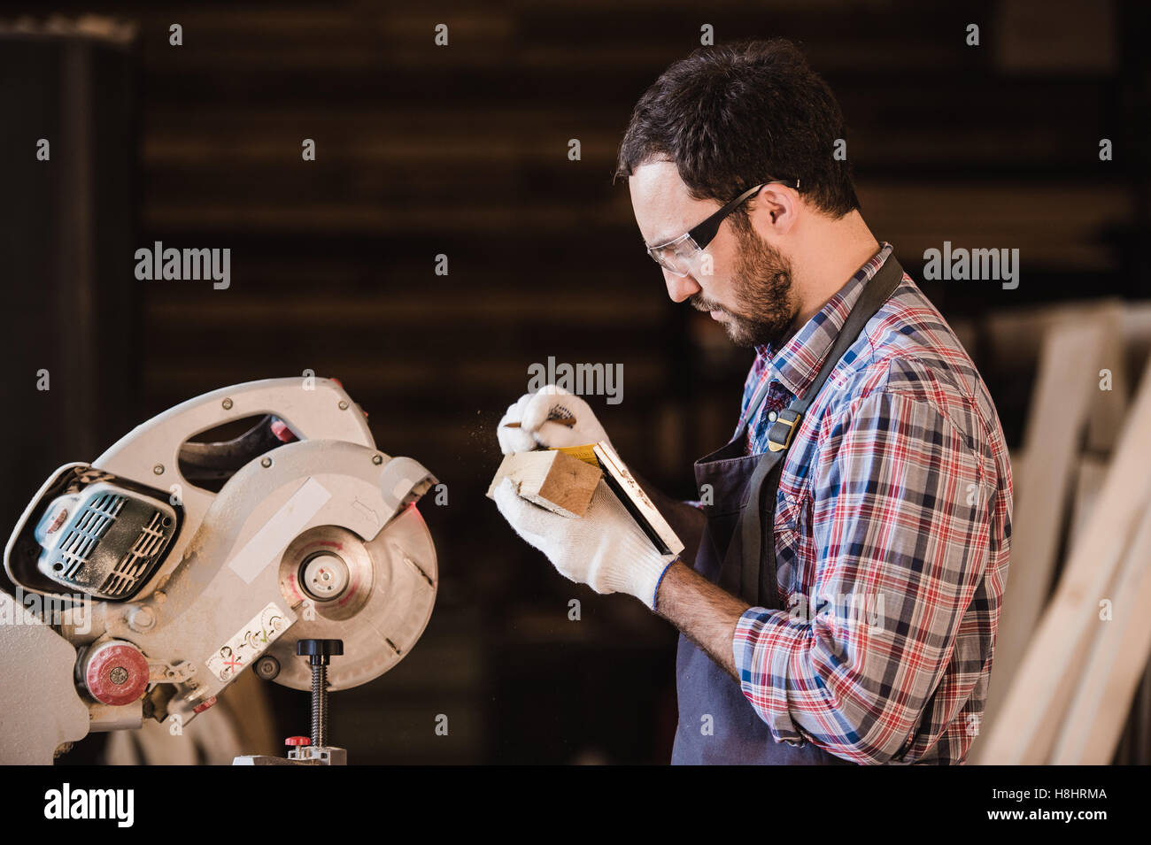 profession, carpentry, woodwork people concept - carpenter with wood ...