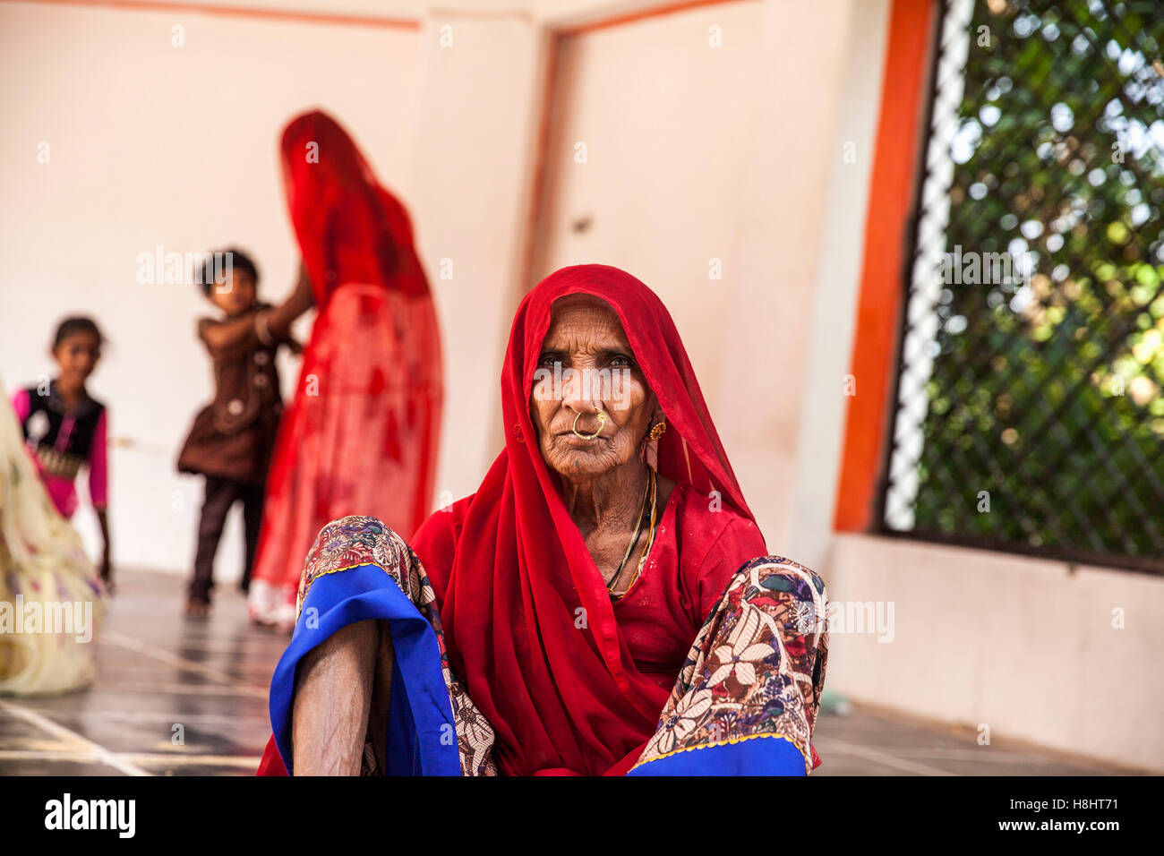 Rajasthani women sitting in a temple courtyard attending a religious ...