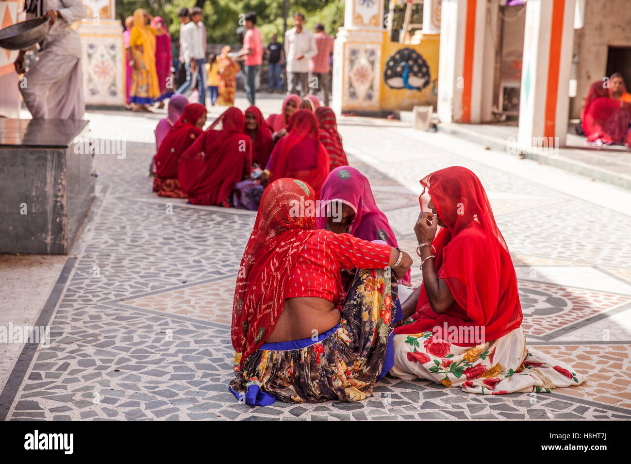 Rajasthani women sitting in a temple courtyard attending a religious ...