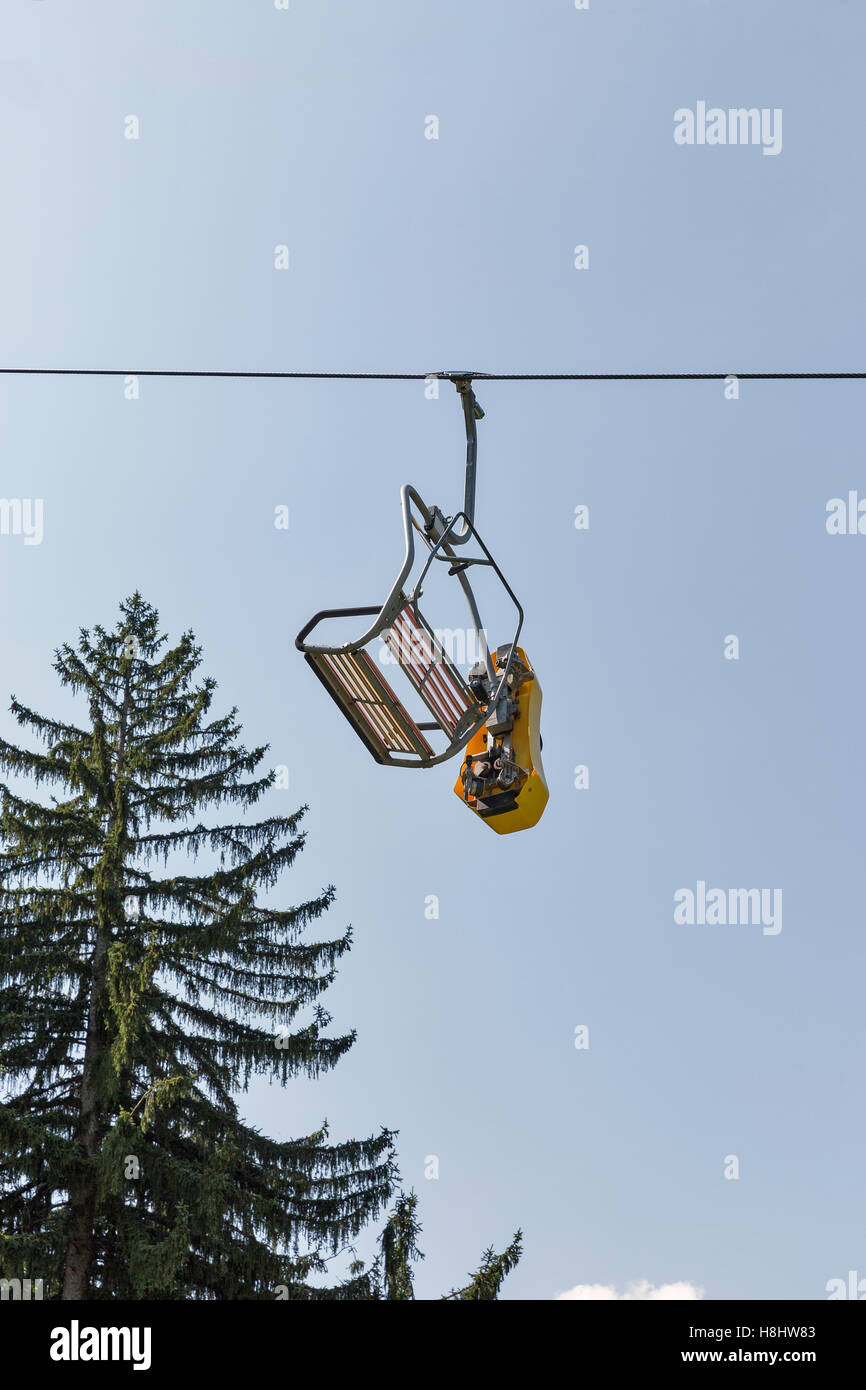 Ski chair lift carry summer toboggan sled against blue sky Stock Photo ...