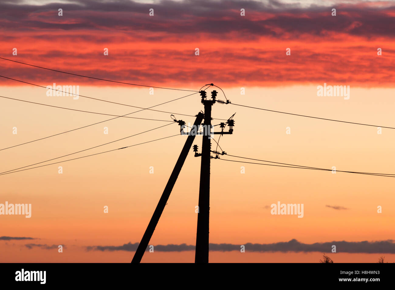 Electric power line against colorful sky at sunset Stock Photo - Alamy