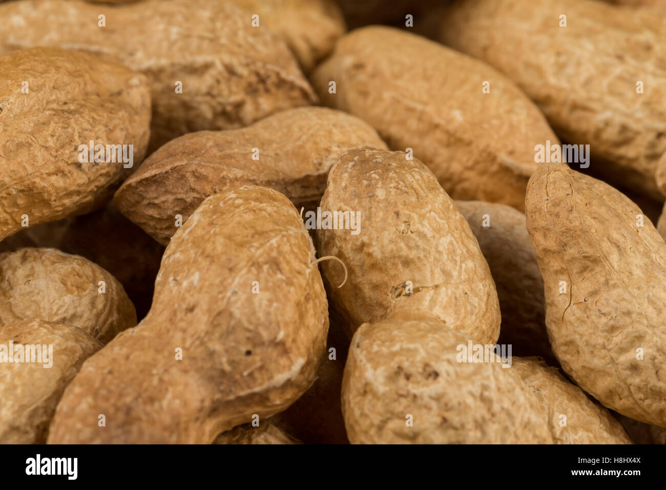 Pile of peanuts shells close up for background Stock Photo - Alamy