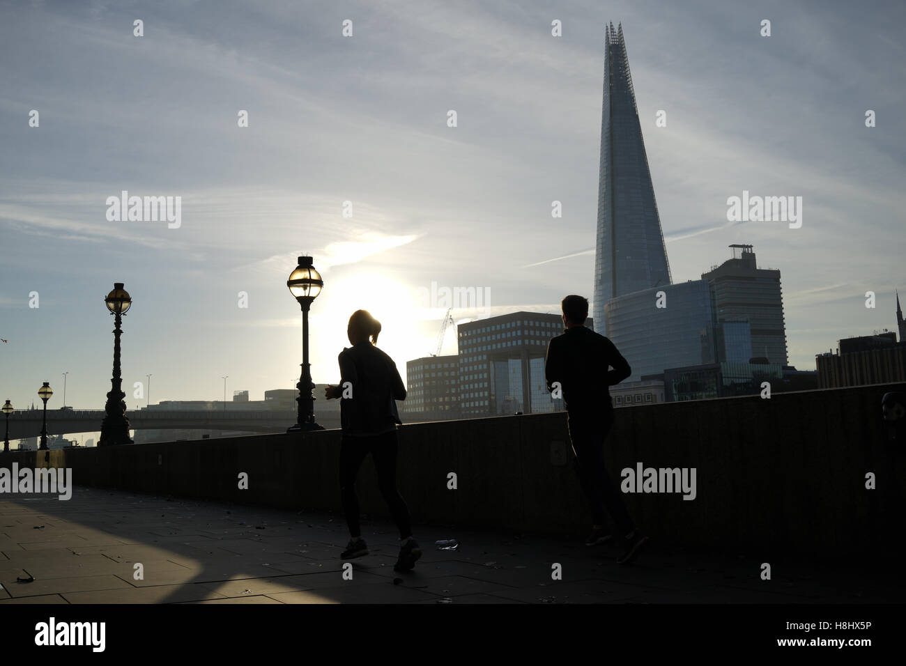A couple running along the Thames river, London Stock Photo - Alamy