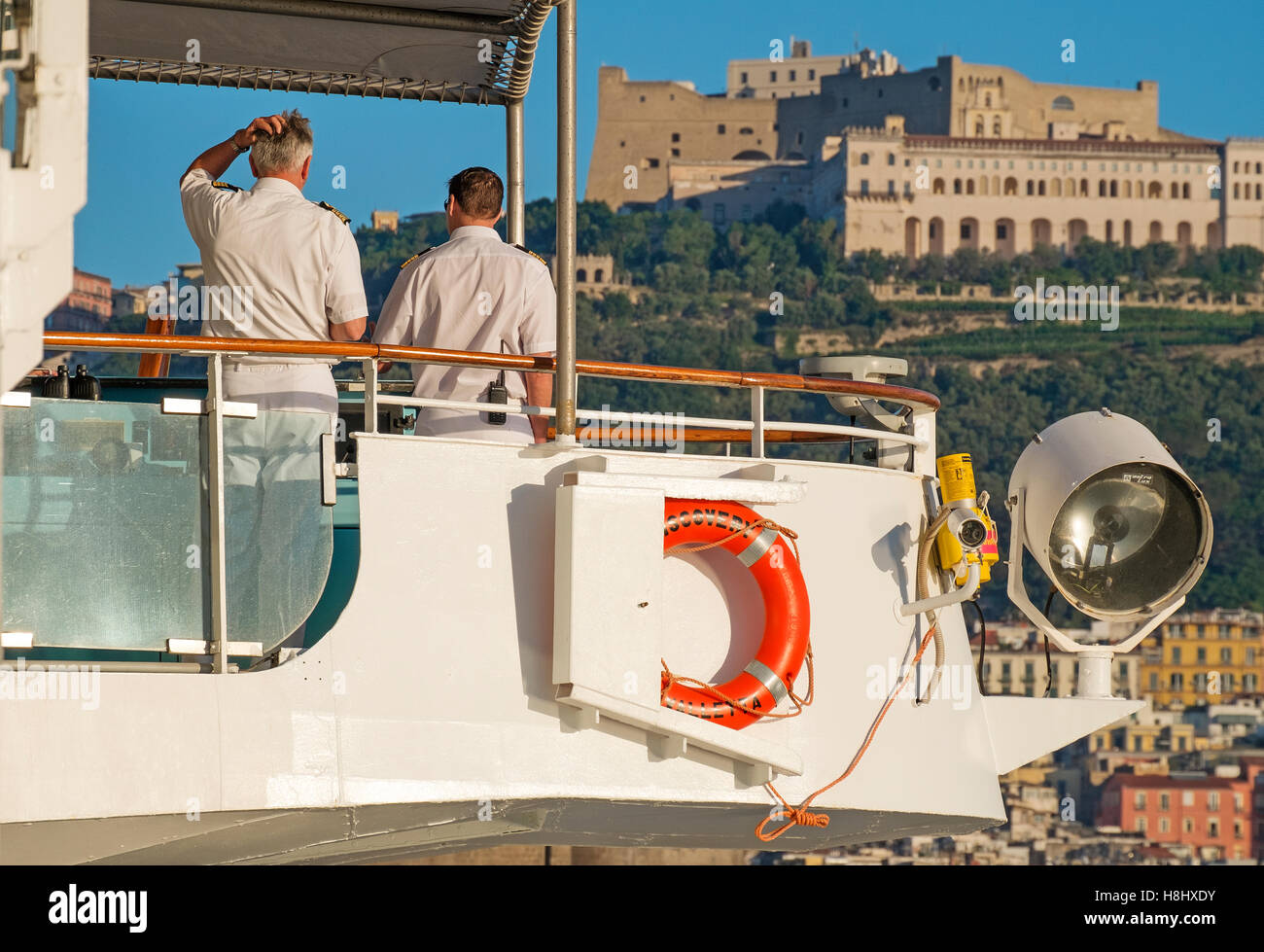 The captain on the bridge of a cruise ship about to enter the port of ...