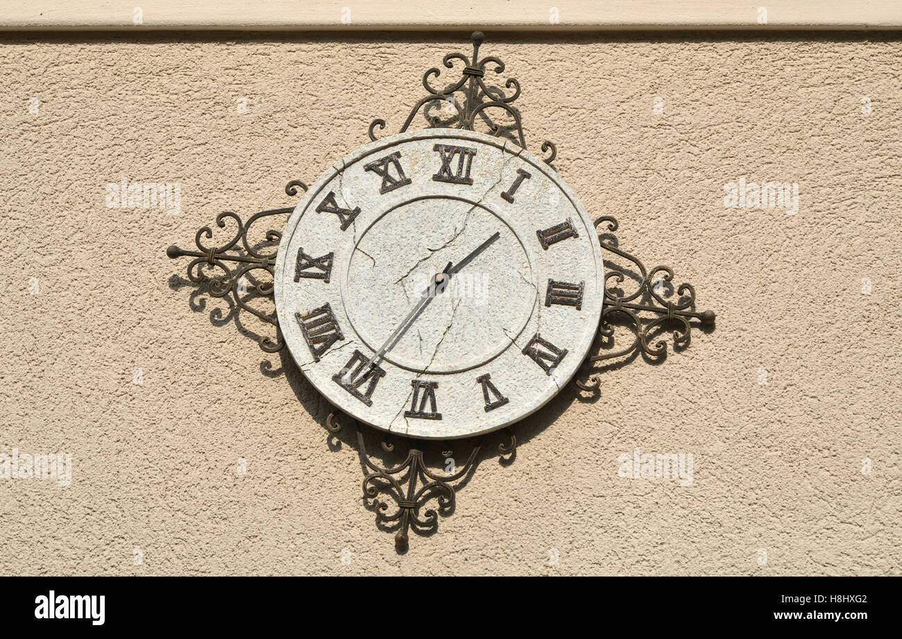 Vintage clock with Roman numbers - showing twenty-five to two - on ...