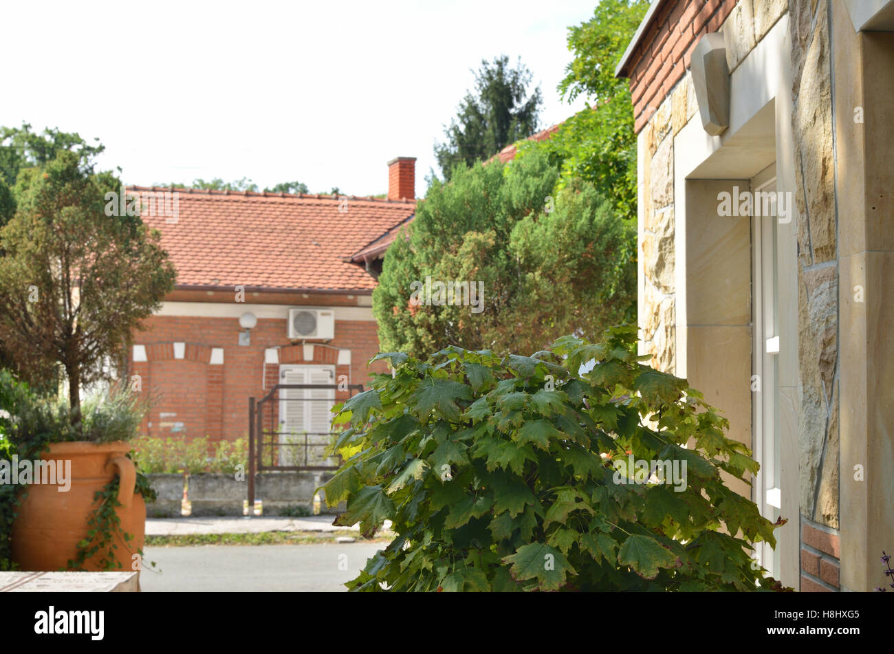 Traditional house of red brick seen through garden across Stock Photo ...