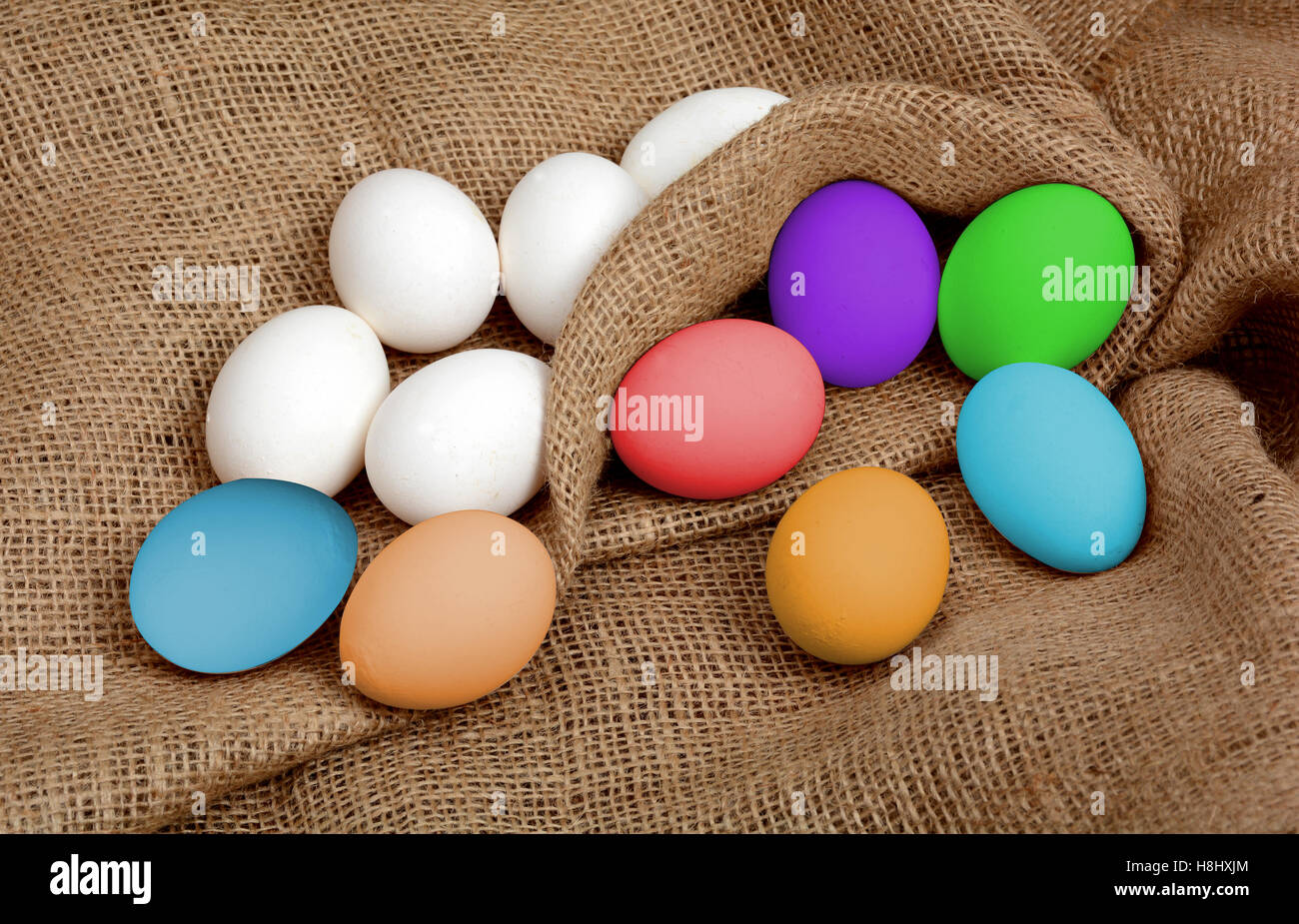 Colorful Easter Eggs with Jute Bag Fabric background Stock Photo - Alamy