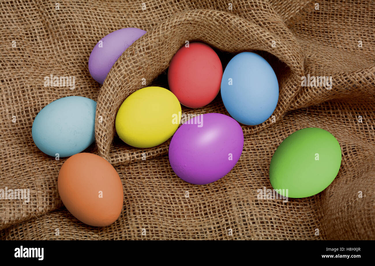 Colorful Easter Eggs with Jute Bag Fabric background Stock Photo - Alamy