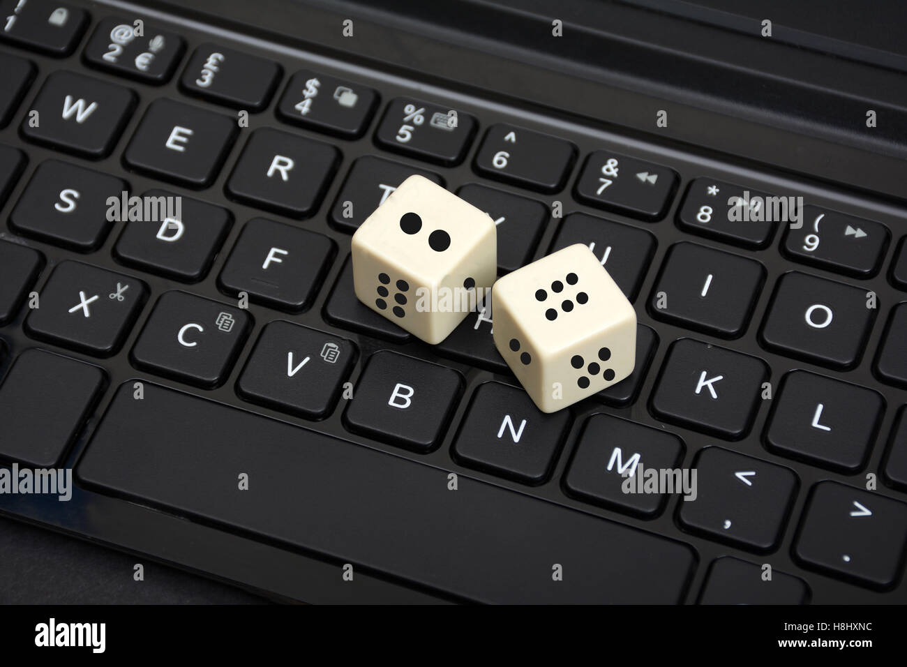 Two White Dice rolled On Keyboard Close Up Stock Photo - Alamy