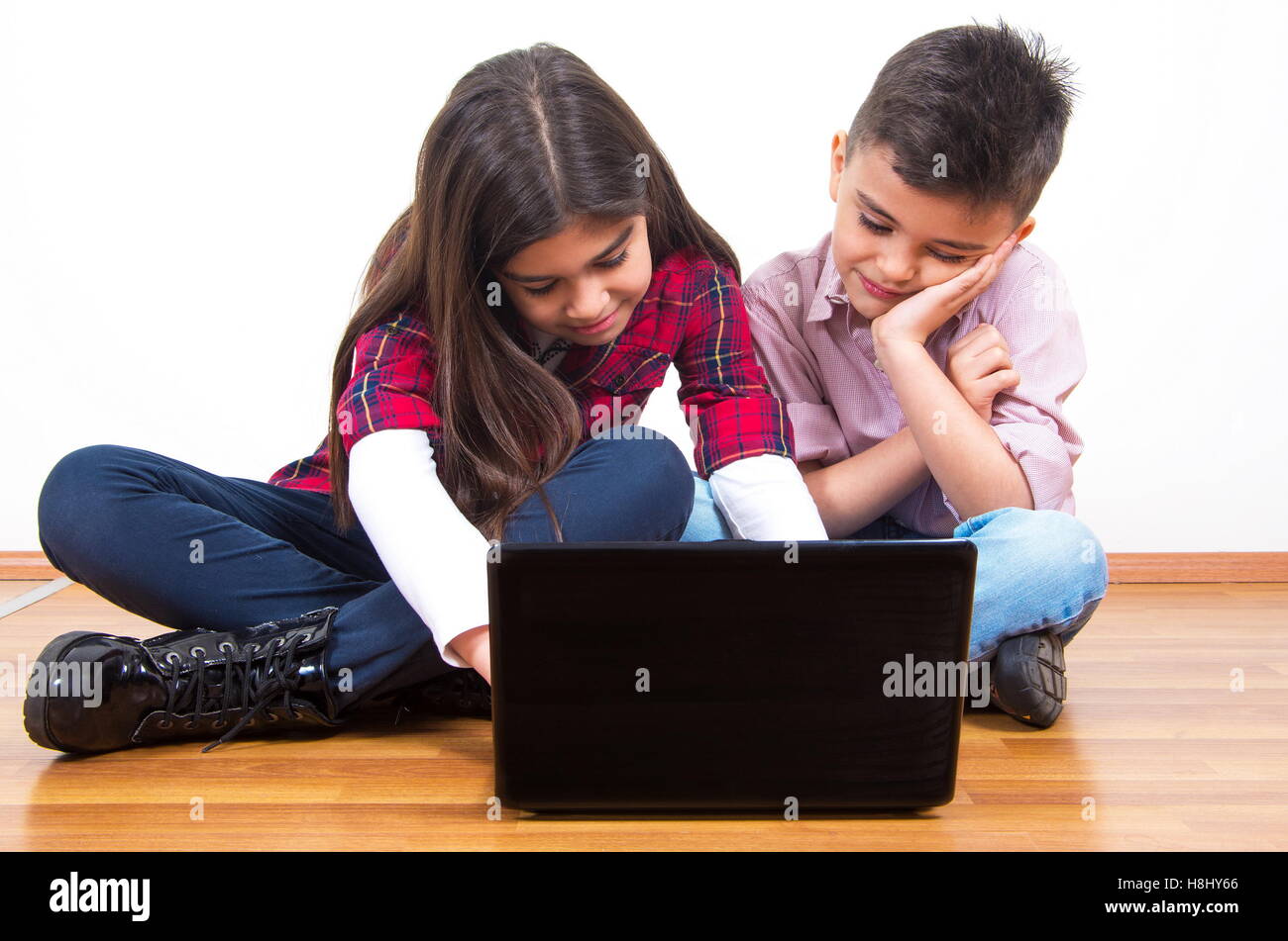 happy brother and sister using the laptop Stock Photo - Alamy