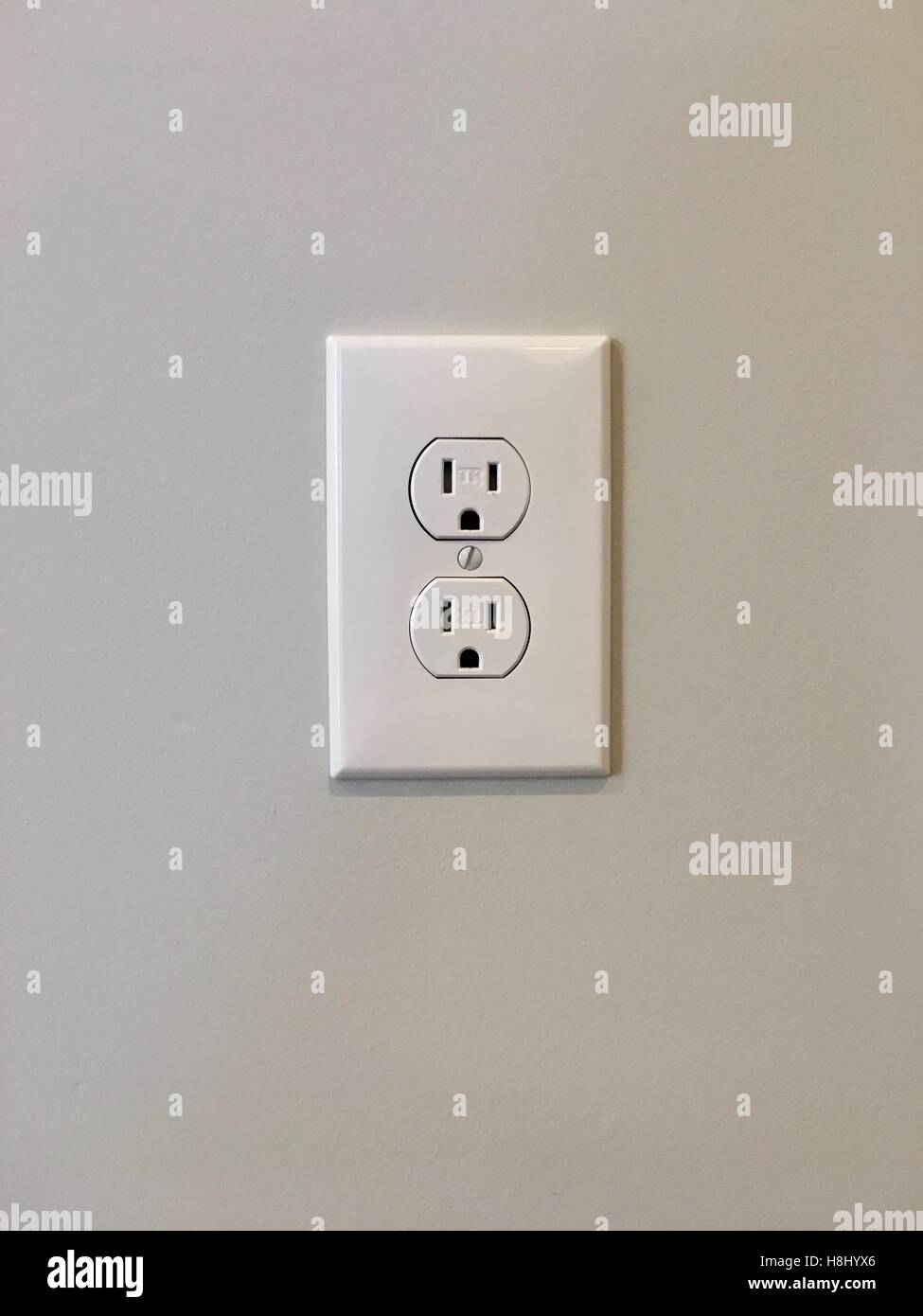 An electrical outlet on the wall of a home Stock Photo - Alamy