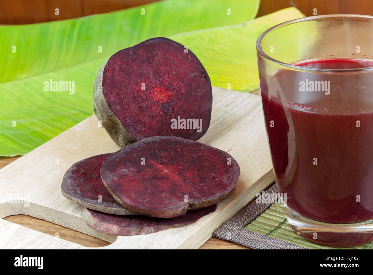 Fresh slices red beetroot and beetroot fruit juice in glass a wood ...