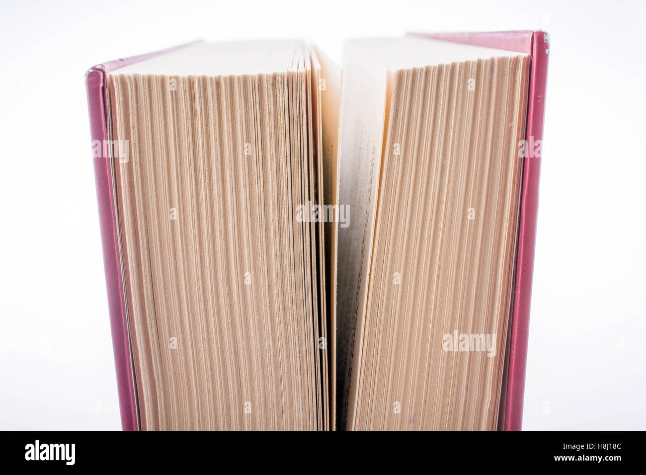 Book pages partly in view on white background Stock Photo - Alamy