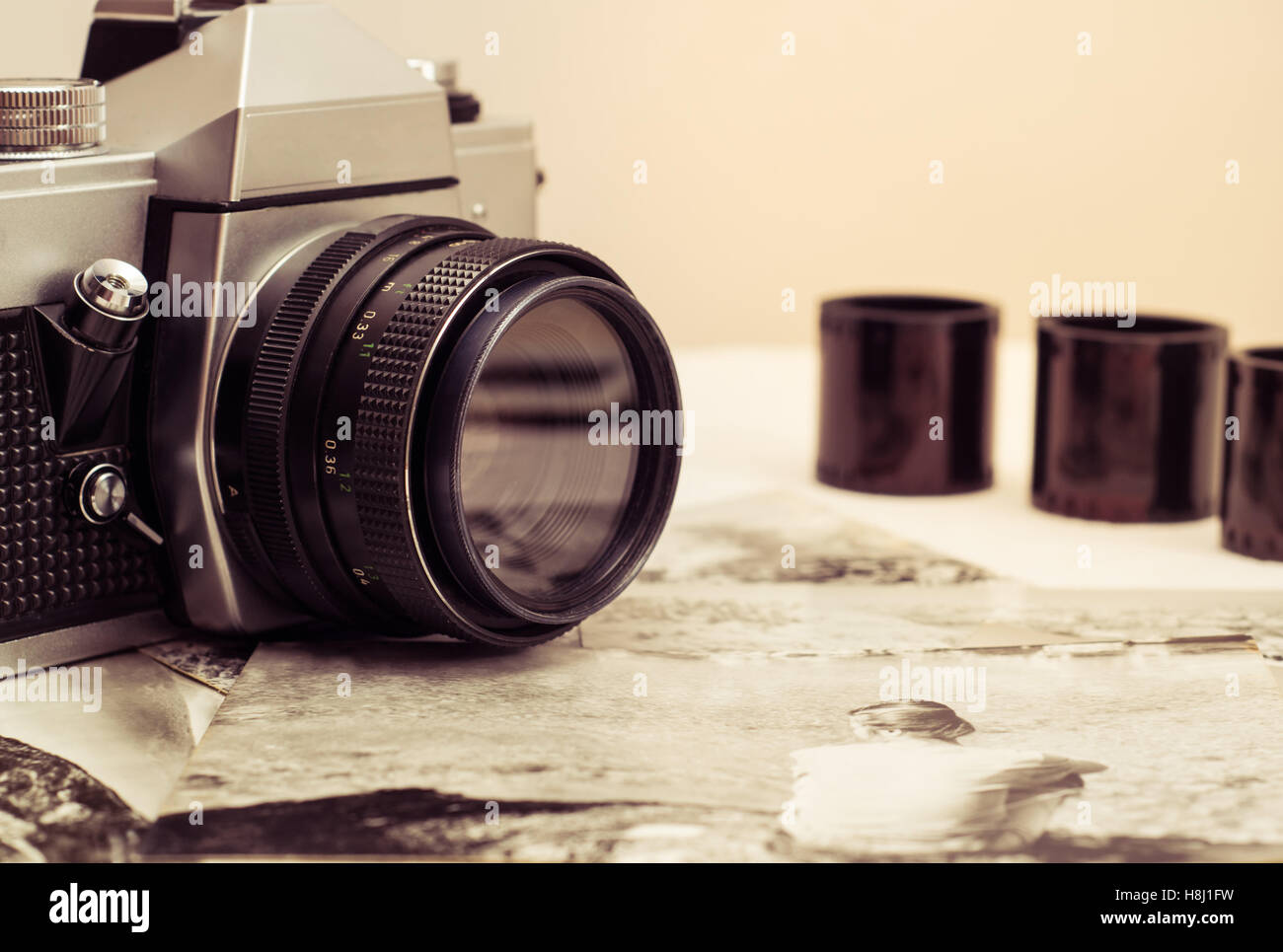 Vintage camera body with film rolls and photos Stock Photo - Alamy