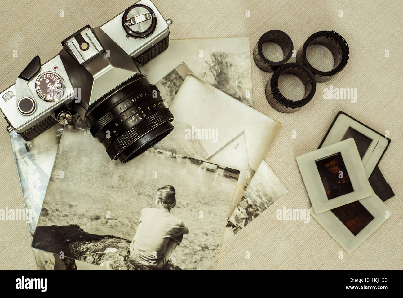 Vintage camera body with film rolls and photos Stock Photo - Alamy