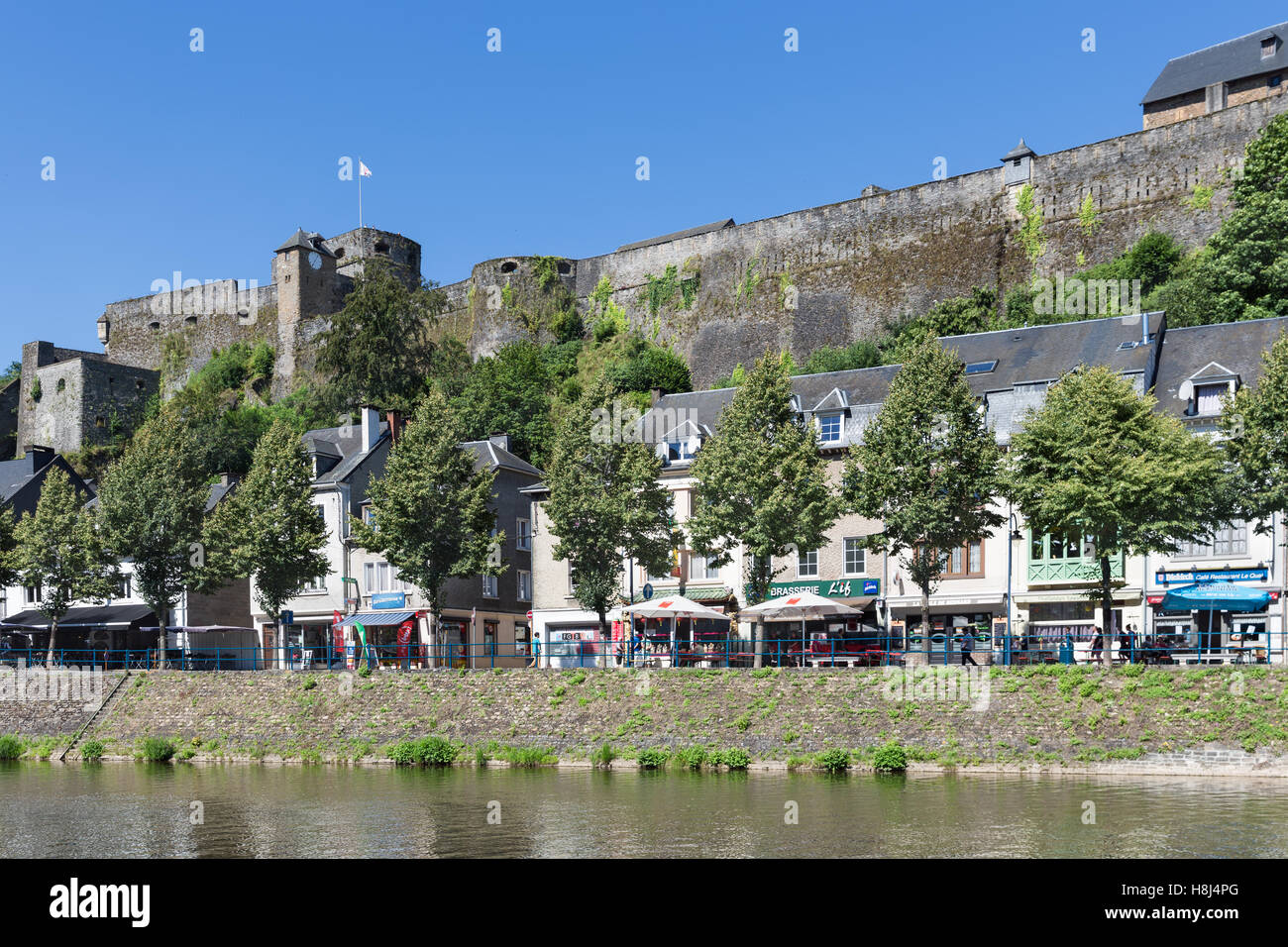 Belgian medieval city along river Semois with promenade and castle in ...