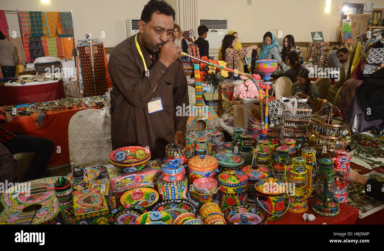 Lahore, Pakistan. 12th Nov, 2016. Pakistani visitors taking interest on ...