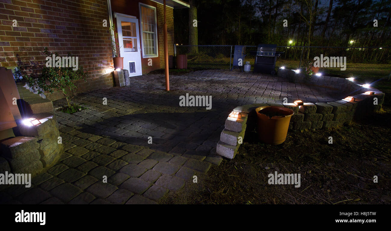 Bricks with sand in a back patio just after dusk Stock Photo - Alamy