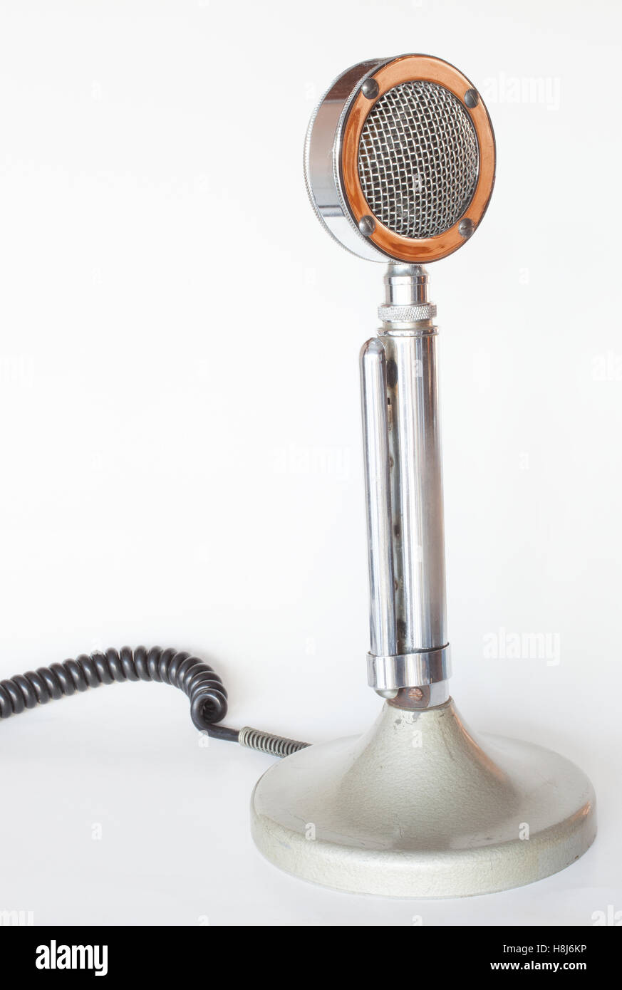 Steel microphone with its element reflecting orange Stock Photo - Alamy