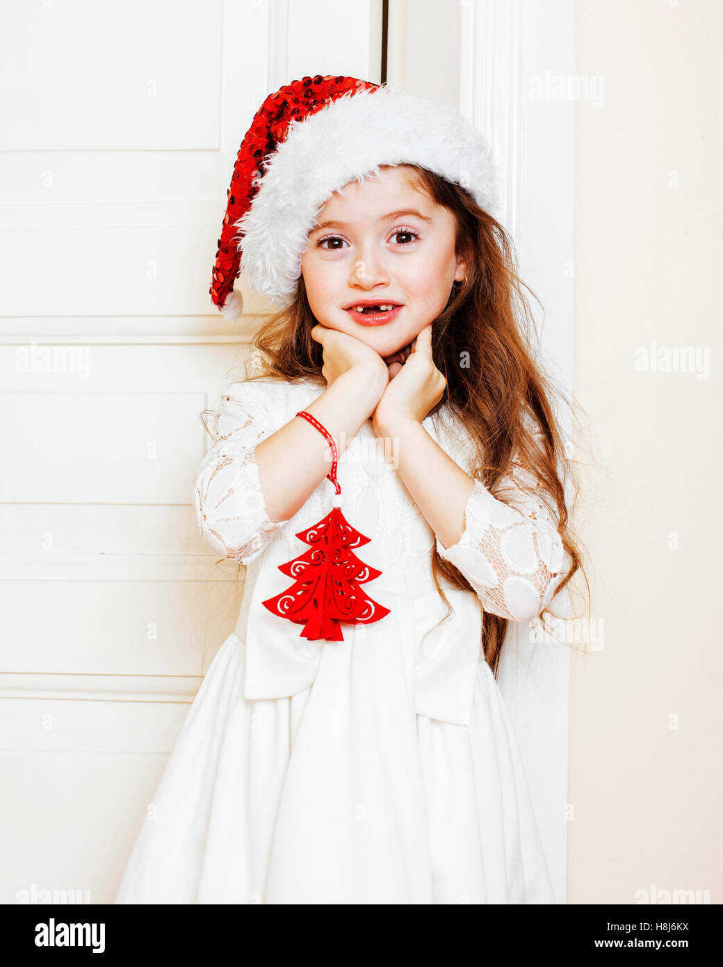 little cute girl in santas red hat waiting for Christmas gifts Stock ...