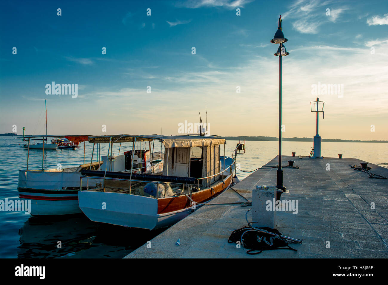 Boats anchor on jetty in hi-res stock photography and images - Alamy
