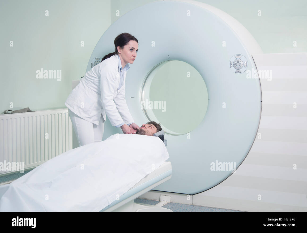 Radiologic technician and Patient being scanned and diagnosed on ...