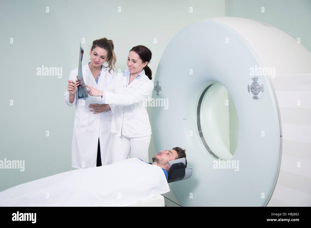Radiologic technician and Patient being scanned and diagnosed on ...