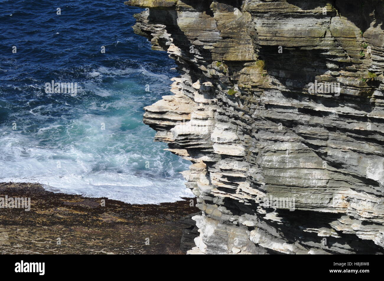Rocky cliffs of the Brough of Birsay meet the Atlantic Ocean Stock ...