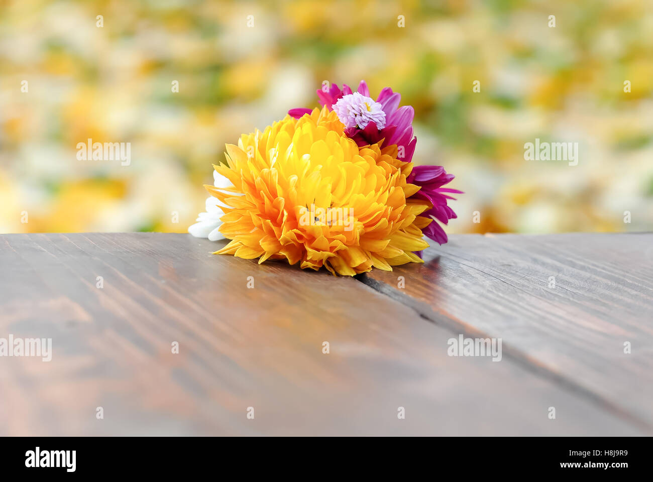 Flowers bouquet on wooden table outdoor Stock Photo - Alamy