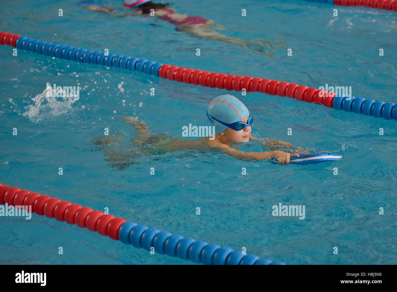 Little boy learning to swim in an indoor pool Stock Photo - Alamy