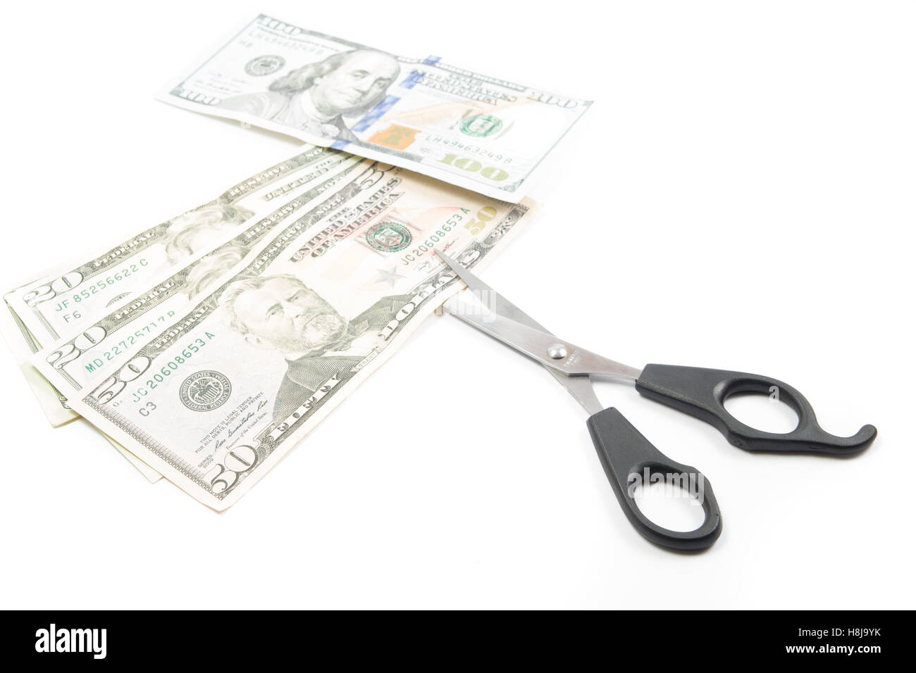Cutting american dollar, money savings reduction concept Stock Photo ...