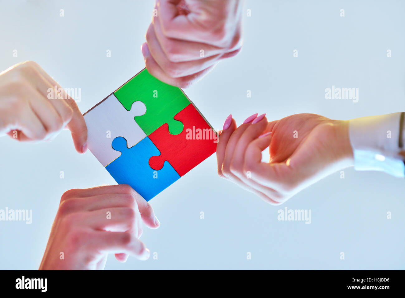 business people group assembling jigsaw puzzle and represent team ...