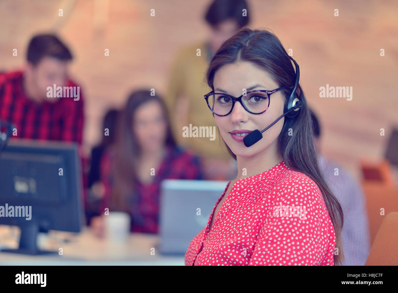Young female in call center team Stock Photo - Alamy