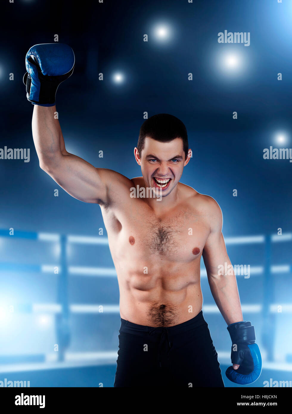 Boxer with an angry face has raised a hand up Stock Photo - Alamy